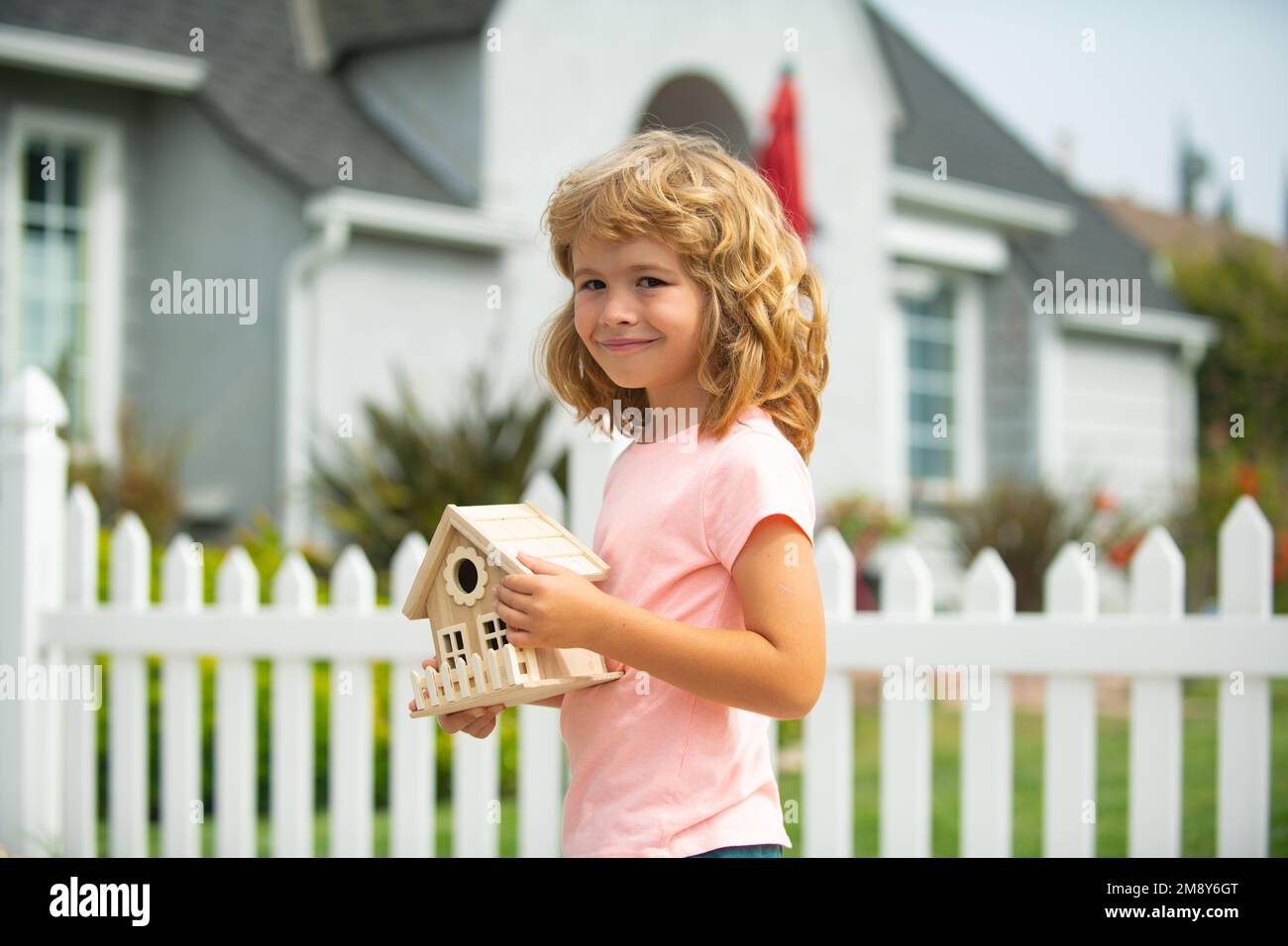 Smart kid hold toy little house. Child making a new dream home. Family ...