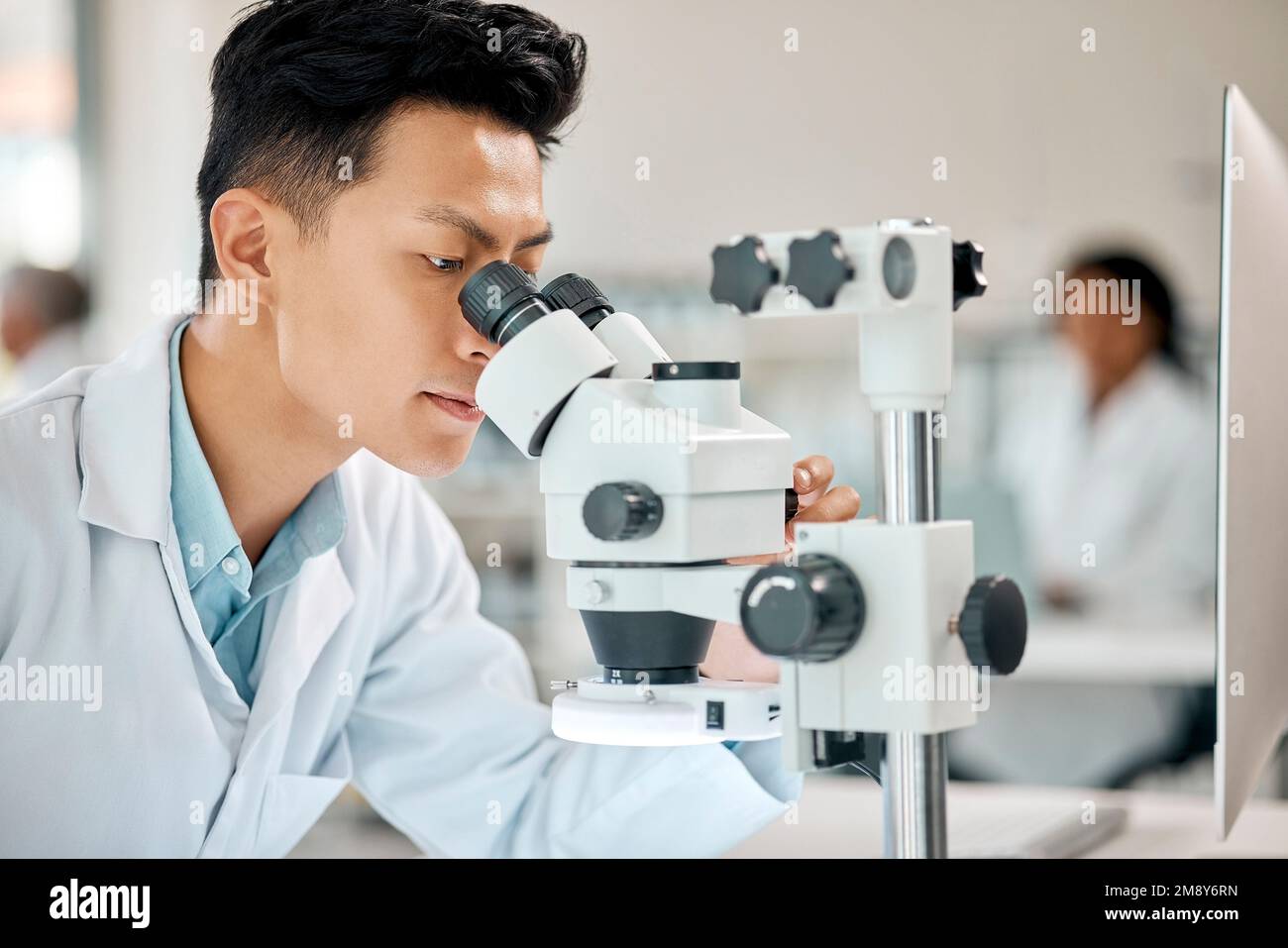 Science is all about making close observations. a young scientist using ...