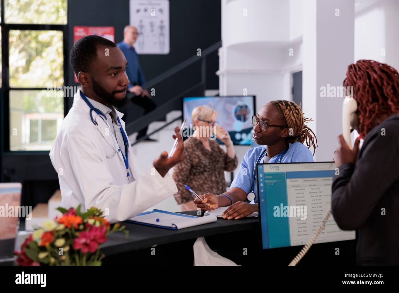 Physician doctor talking with medical receptionist discussing patient ...