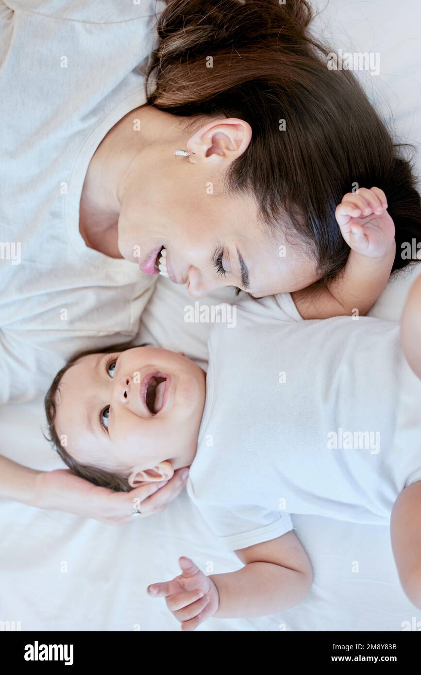 Youre upside down mum. a young mother bonding with her baby at home ...