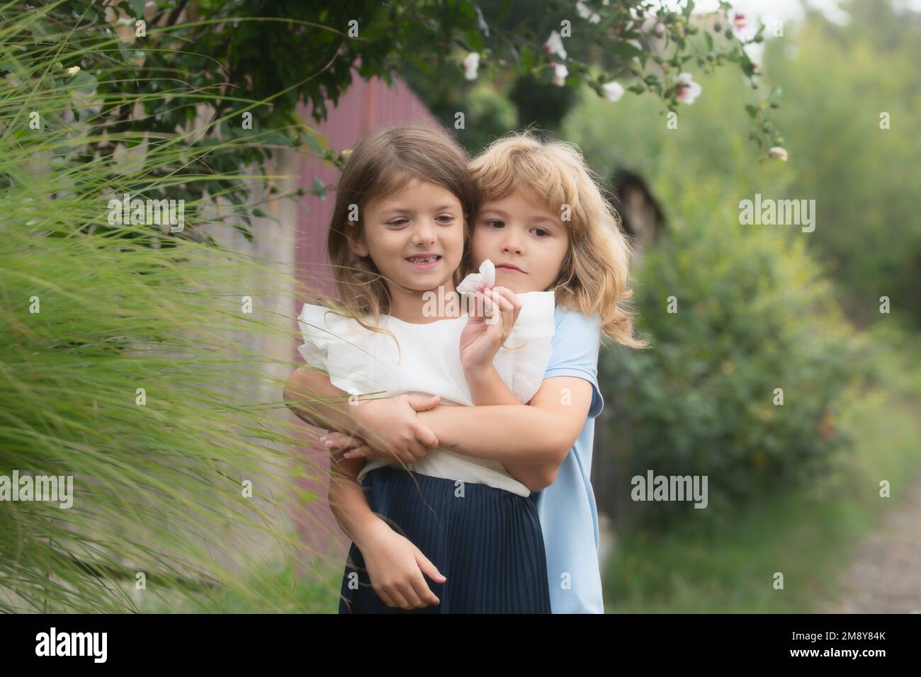 Hugging and kissing kids couple. Little lovely children outdoor ...