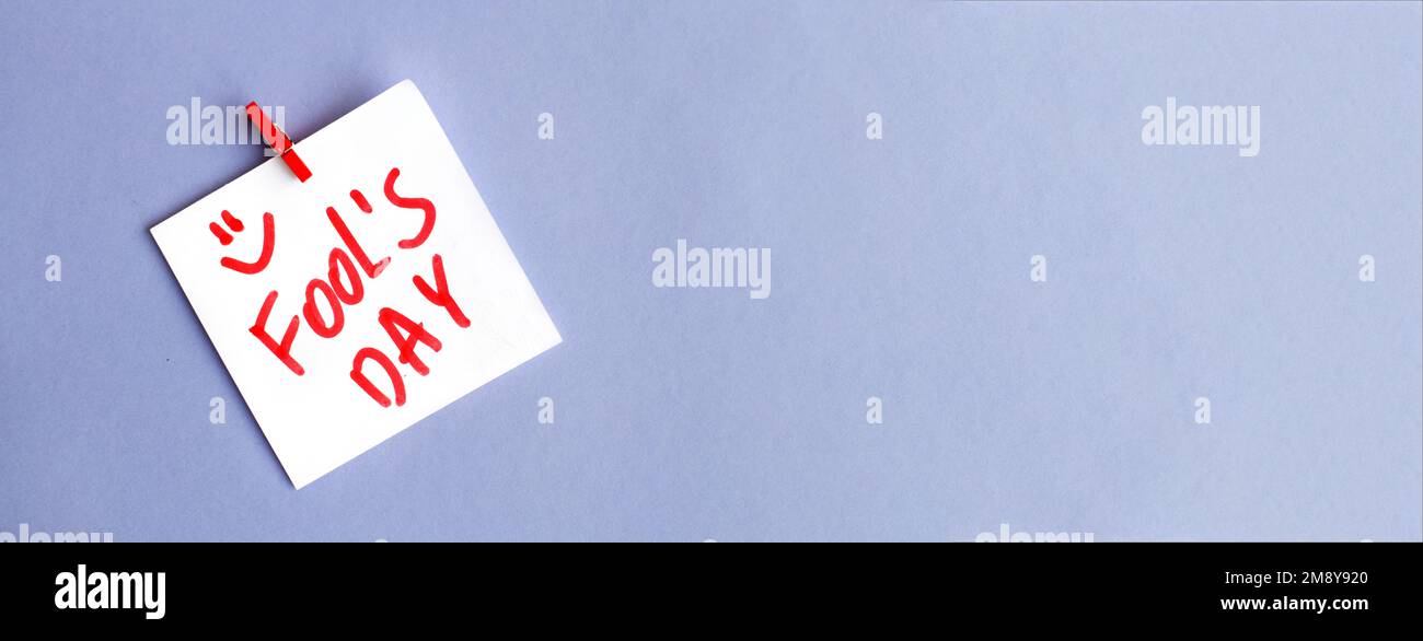 sticker with text fools day hanging on the pin on the veri peri purple ...