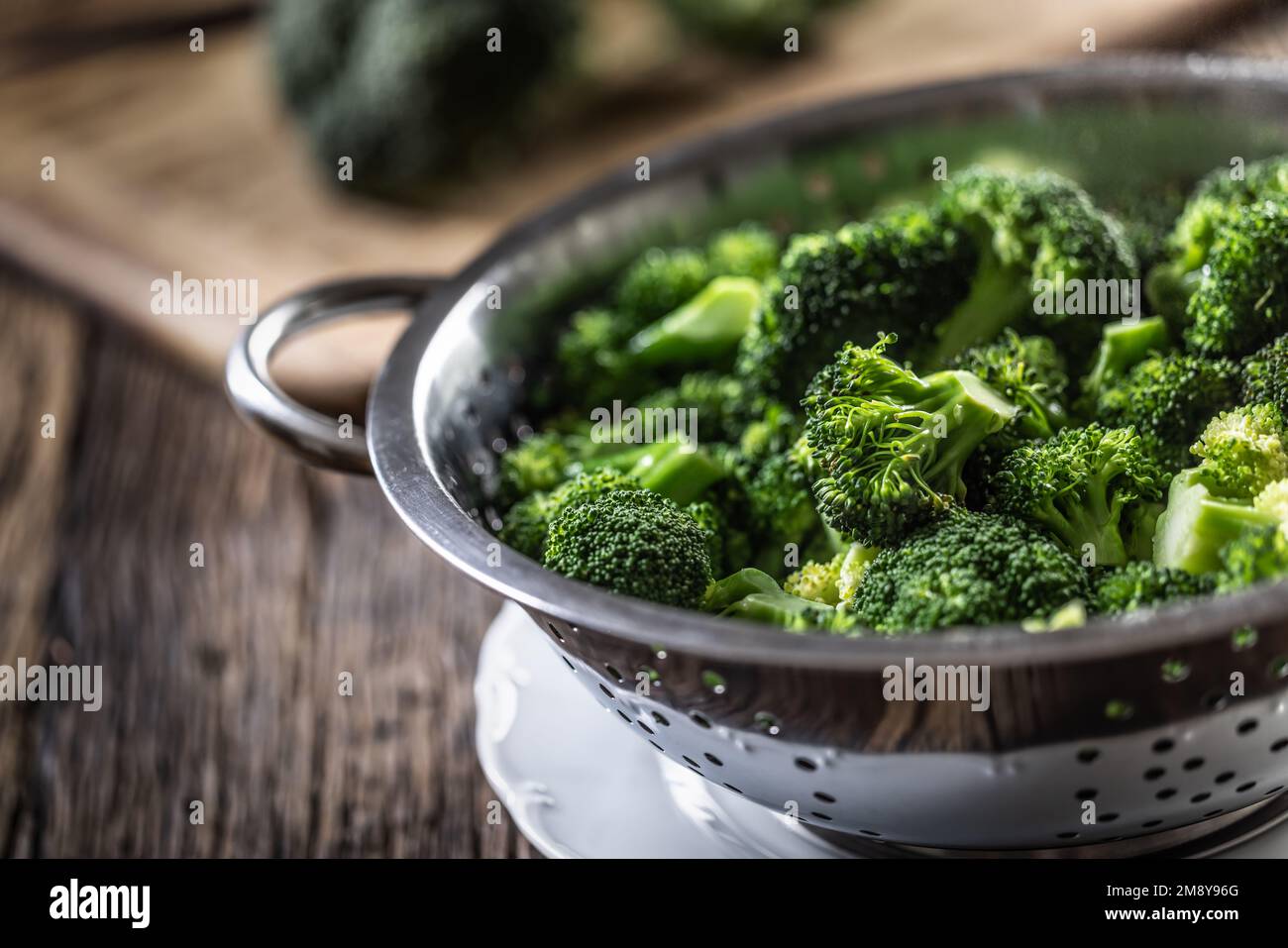 Steamed broccoli in a stainless steel steamer. Healthy vegetable ...