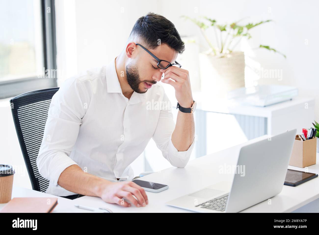 This is working on my last nerve. a handsome young businessman sitting ...