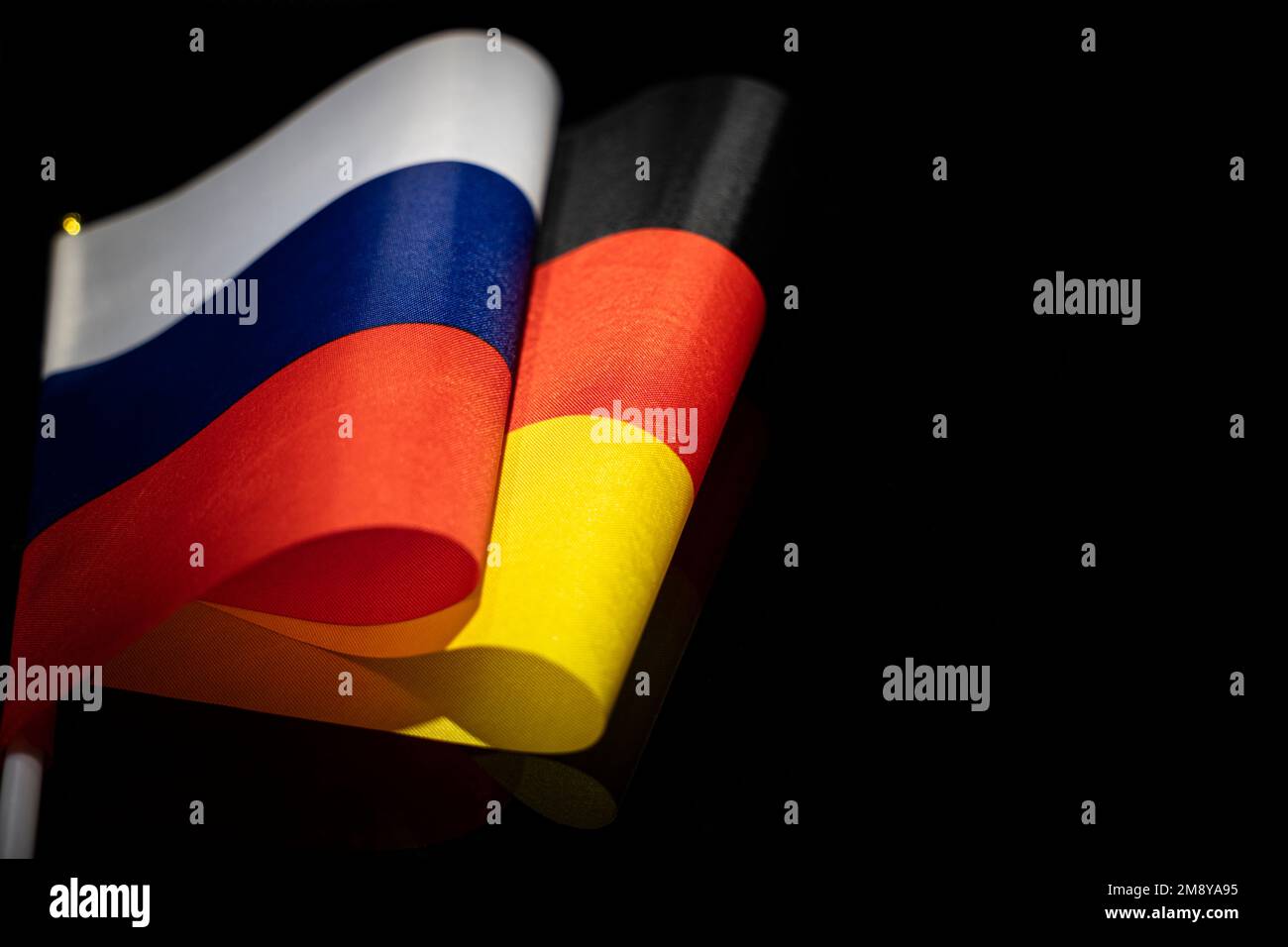 flags of Germany and russia on a black background. The concept of ...