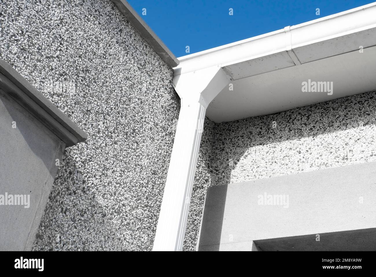 White gutter on the rooftop of house wall rain metal. White plastic ...