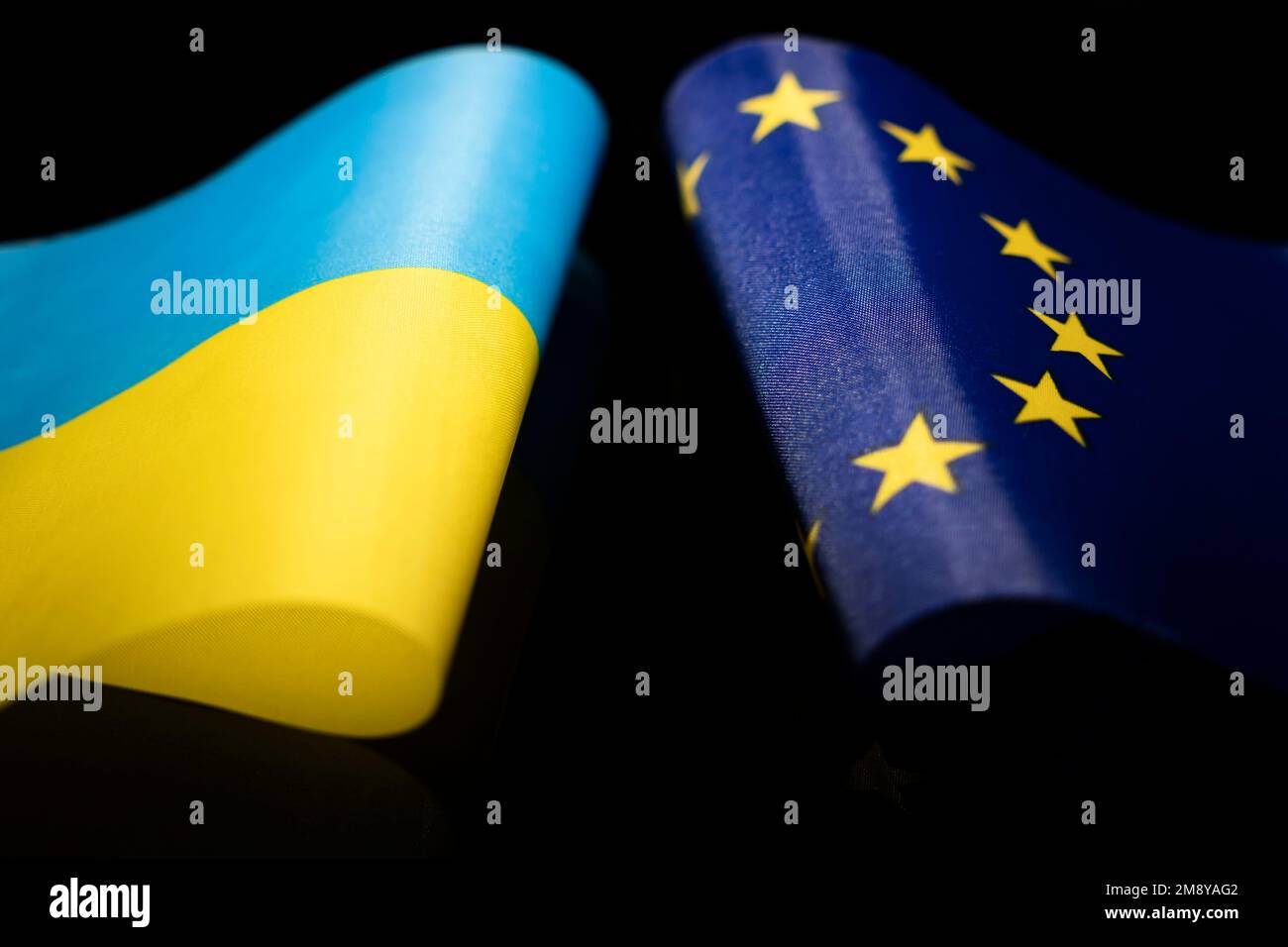 flags of European Union and ukraine on a black background. The concept ...
