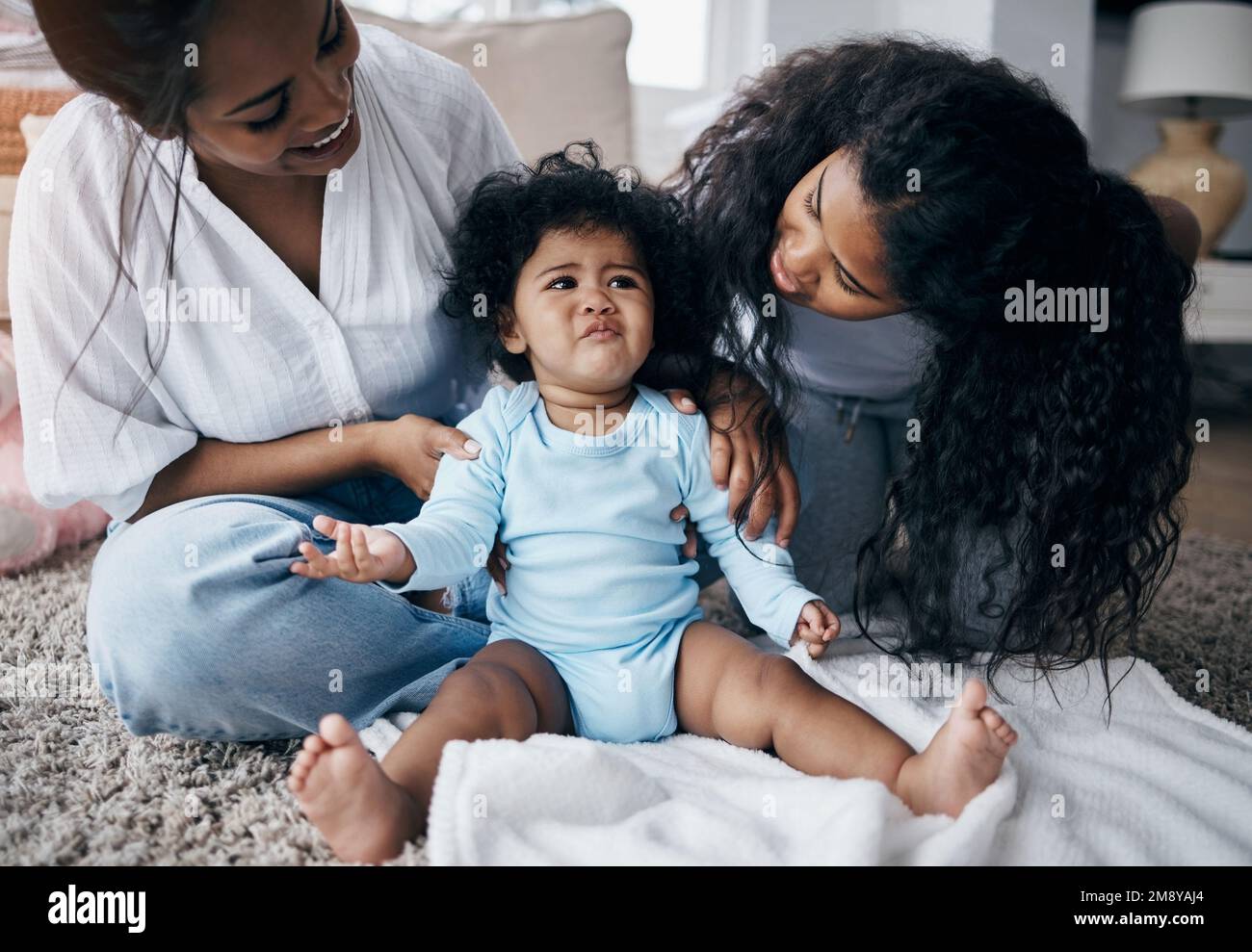 Is someone grumpy. an attractive young woman sitting on the living room ...