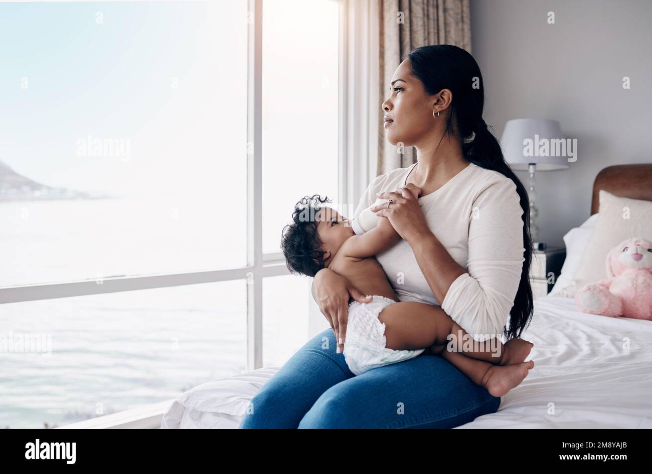 Its almost time for her nap. an attractive young woman sitting on the ...