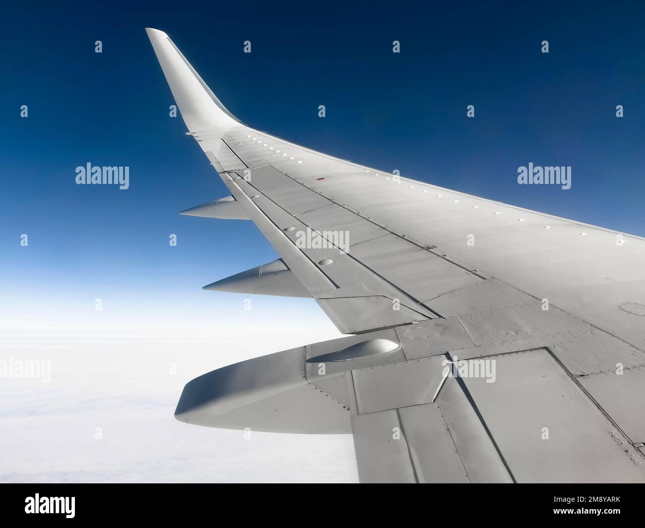 White wing from airplane window on sunny day. Great views of landscape ...