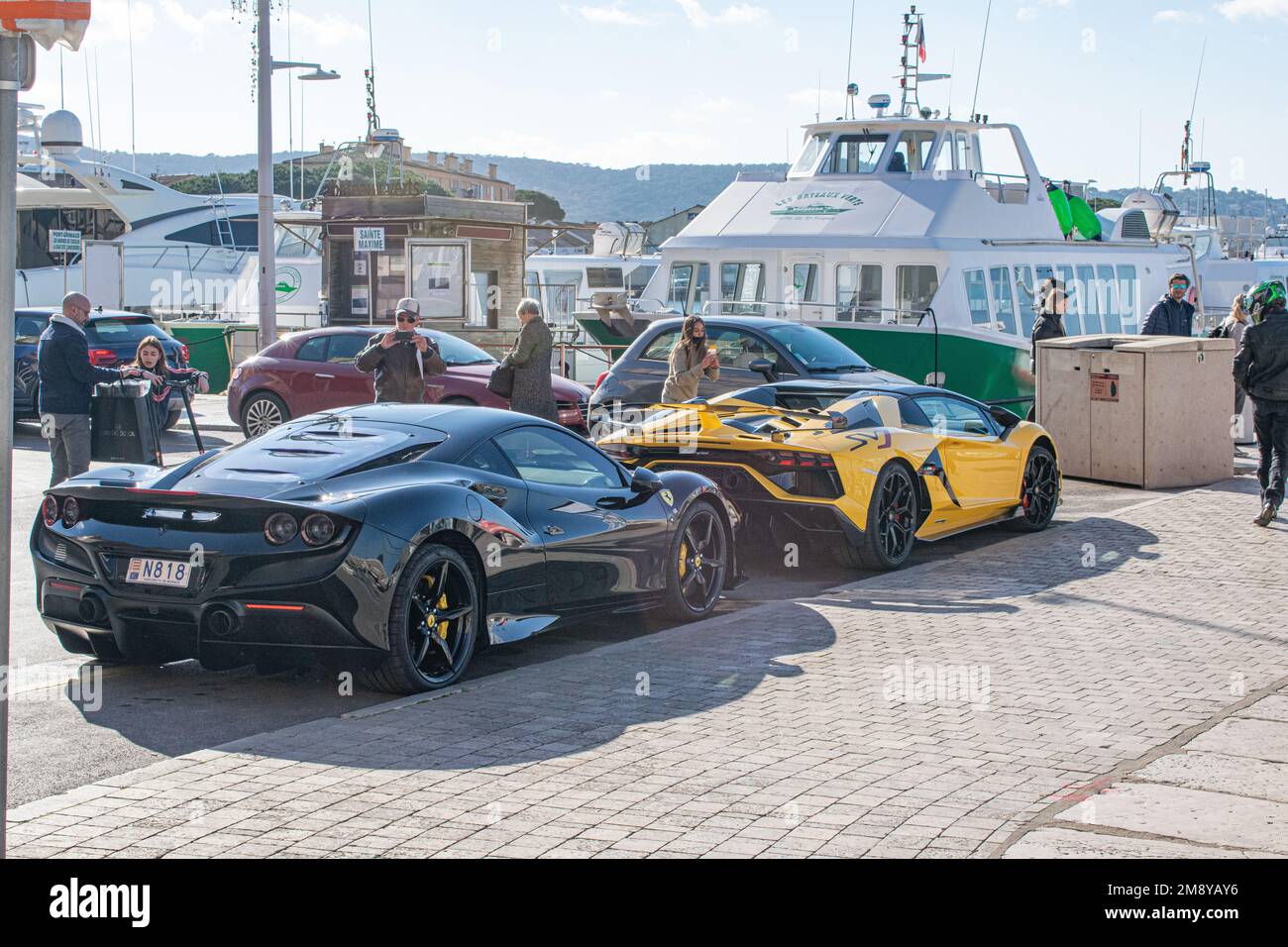 Saint Trope harbor with luxury cars on the dock Stock Photo - Alamy