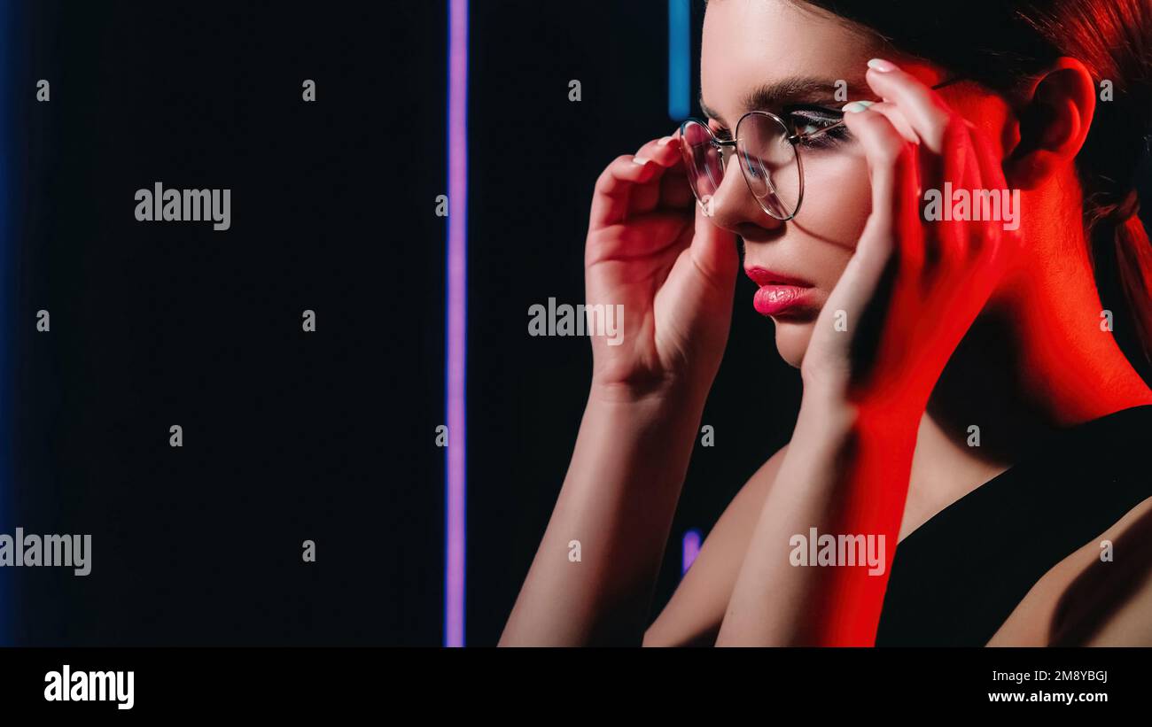 retro optic 90s look neon light girl face glasses Stock Photo - Alamy