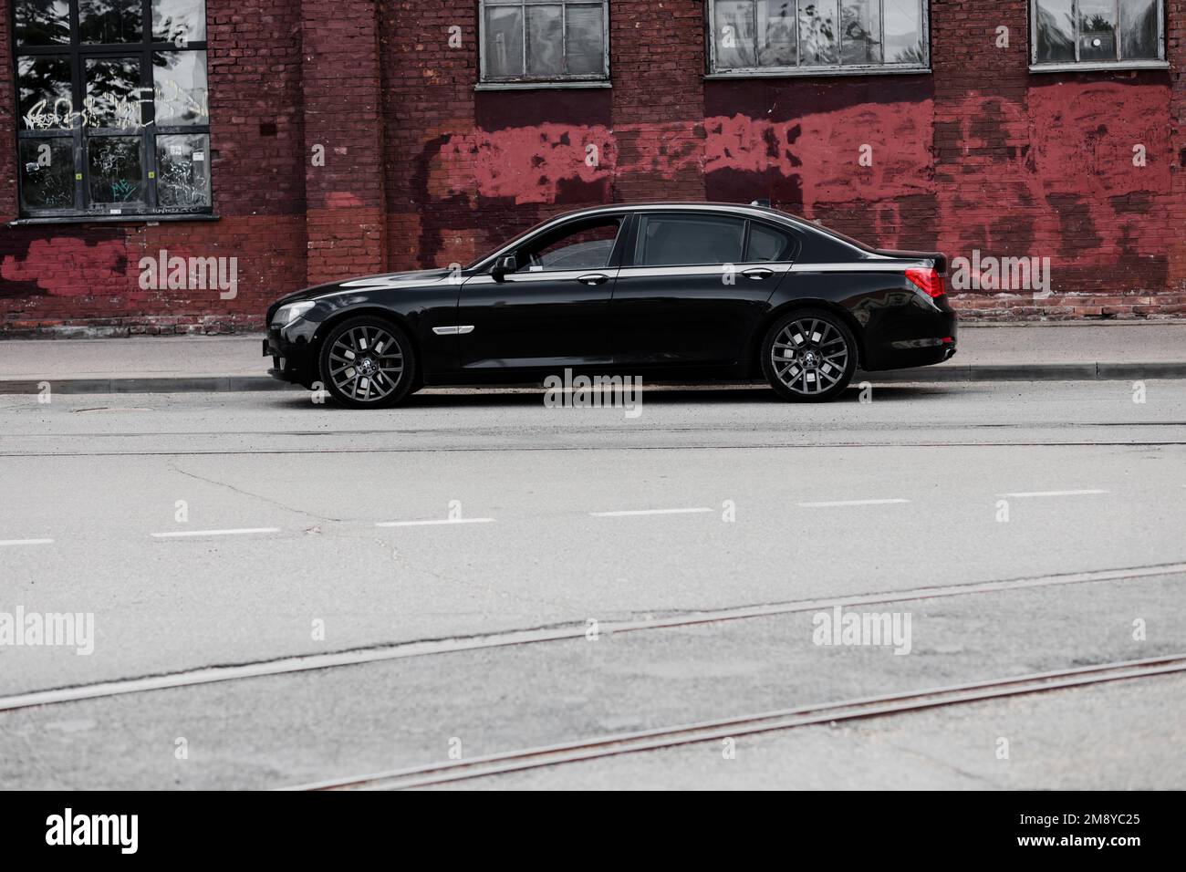 Minsk, Belarus, January 2023 - luxury BMW car parked near an old brick ...