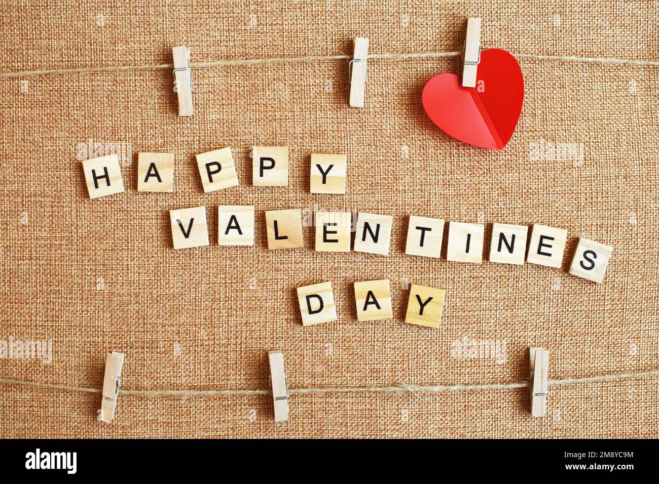 inscription happy Valentine's day with hearts on clothes pin on brown ...