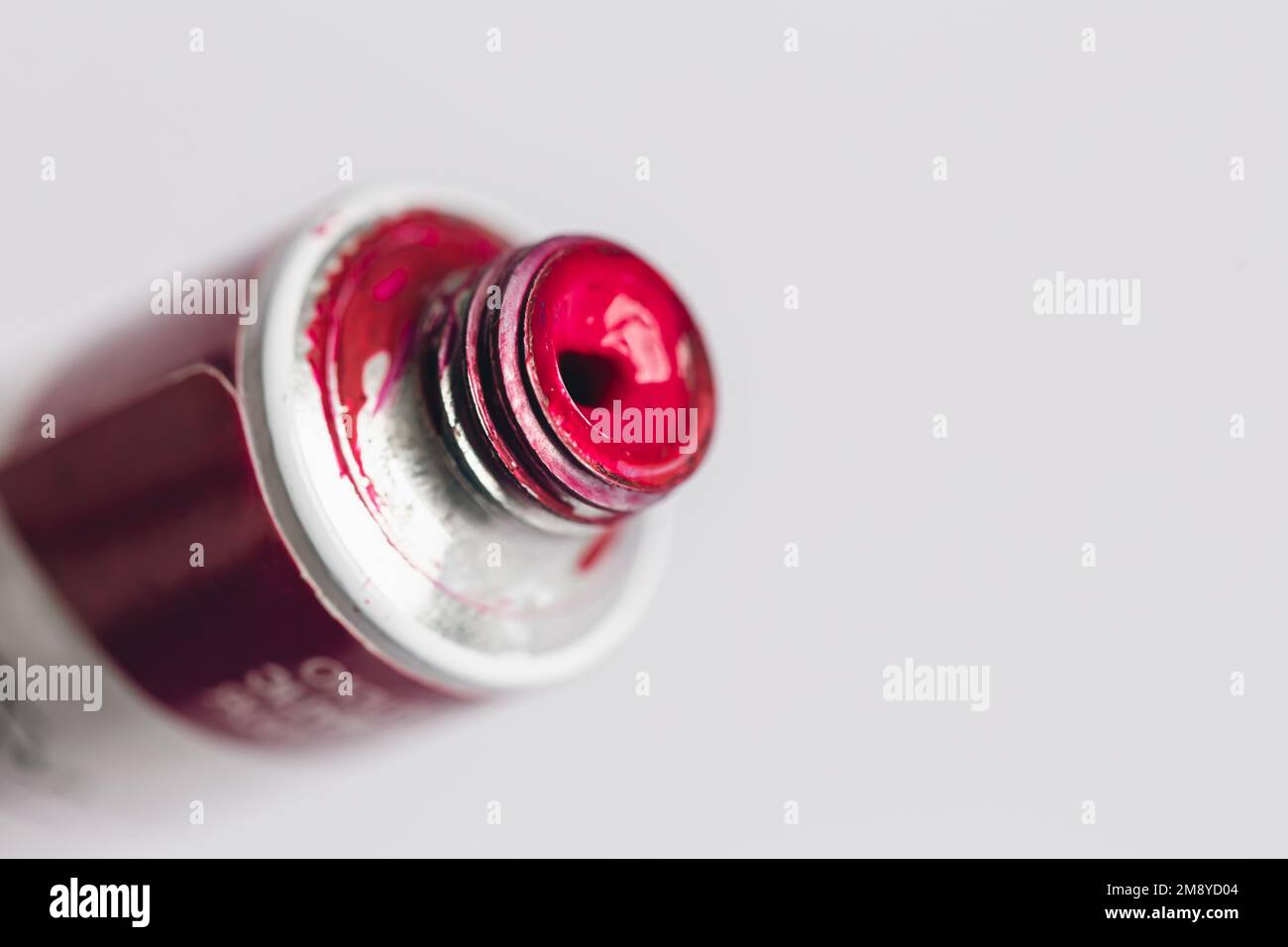 Metal acrylic tube with pink paint for drawing close up on white ...