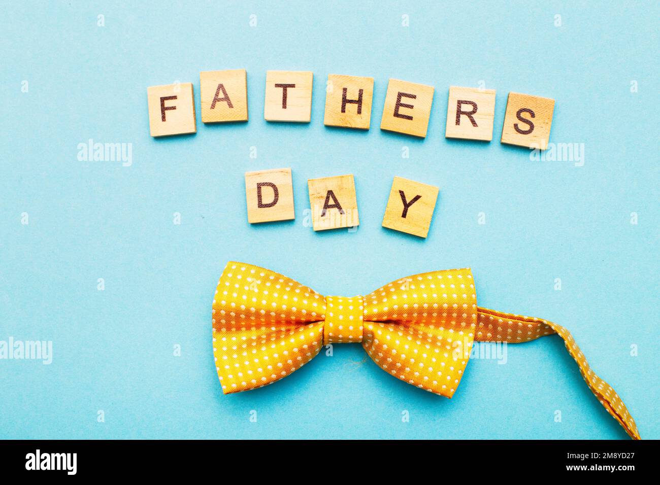 happy father's day lettering made by wooden cubes on a blue background ...