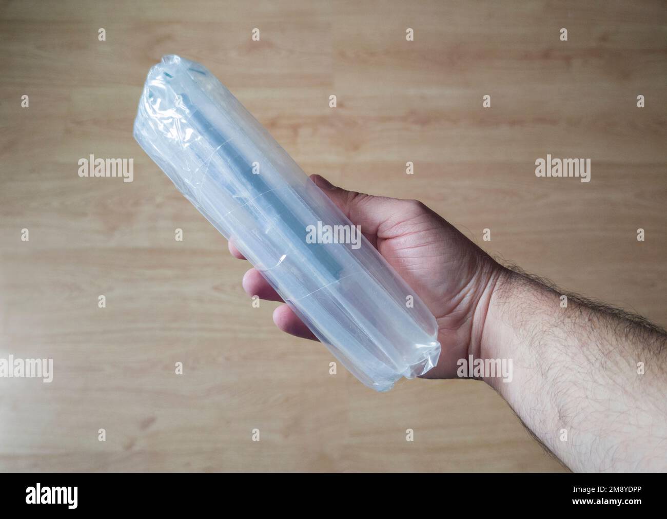 Hand holds a product wrapped with inflatable packaging columns bags ...