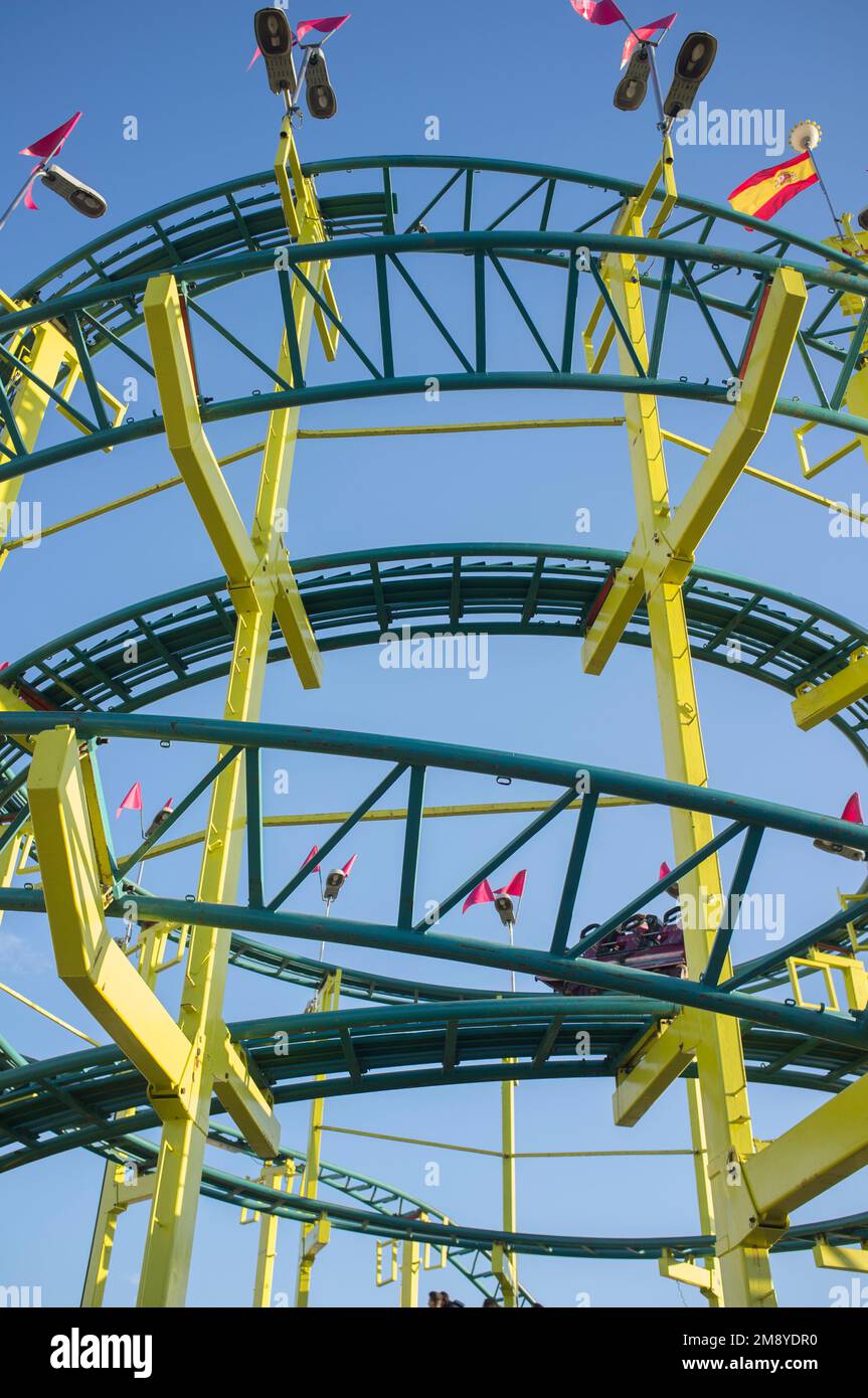 Roller coaster circles structure. Funfair attraction over blue sky seen ...