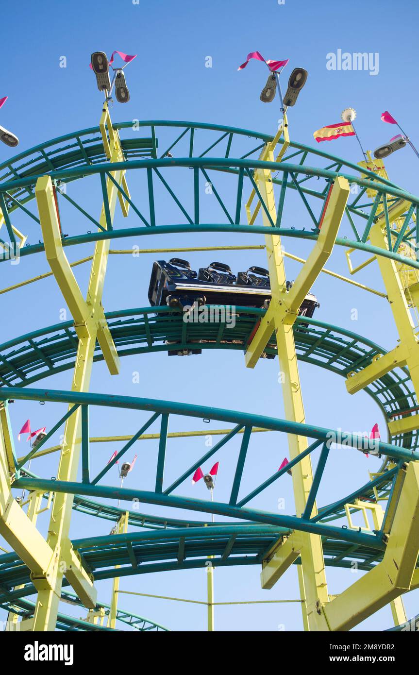 Roller coaster circles structure. Funfair attraction over blue sky seen ...