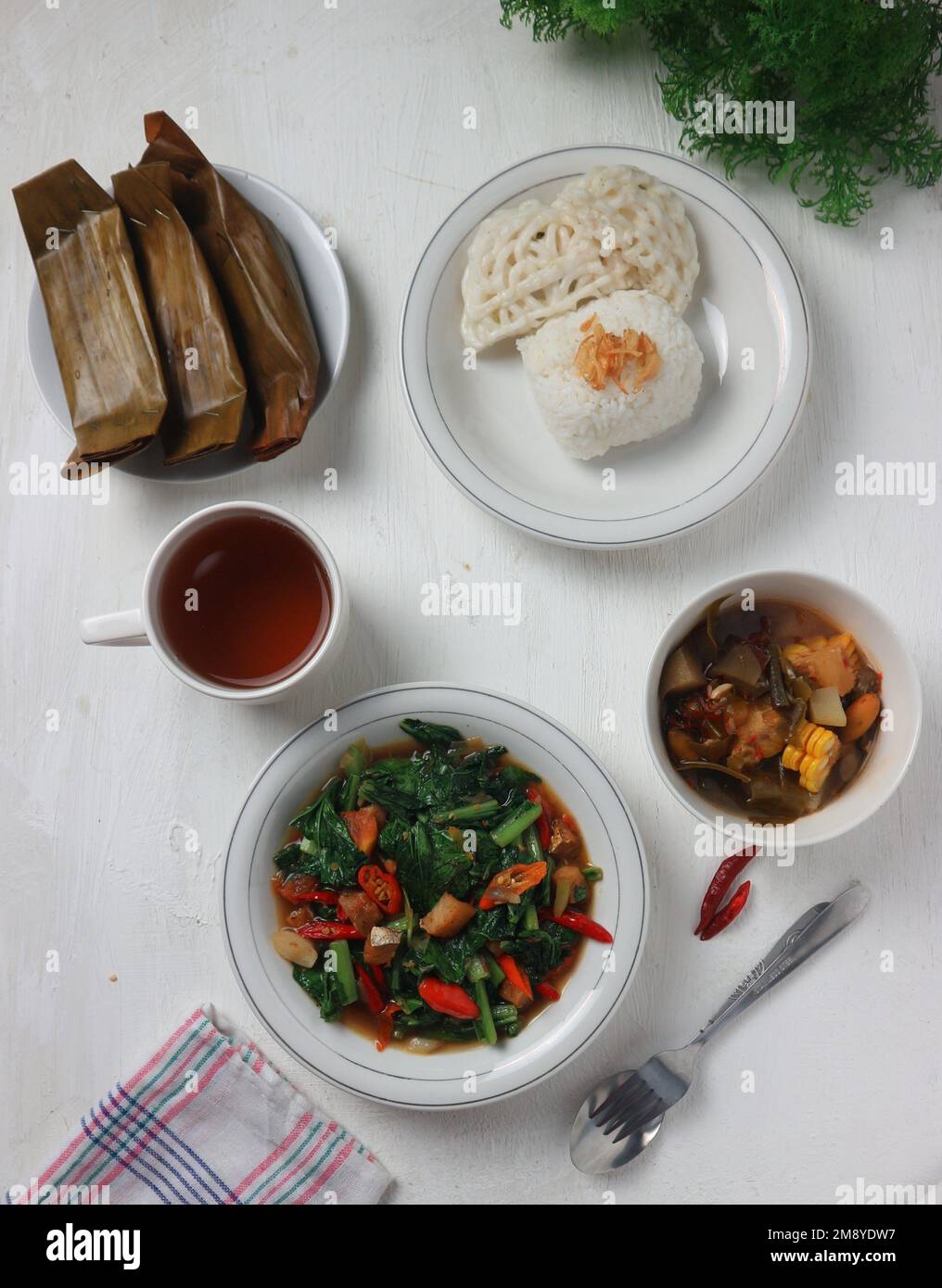 Indonesian traditional dish. rice, stir-fried mustard greens, tamarind ...