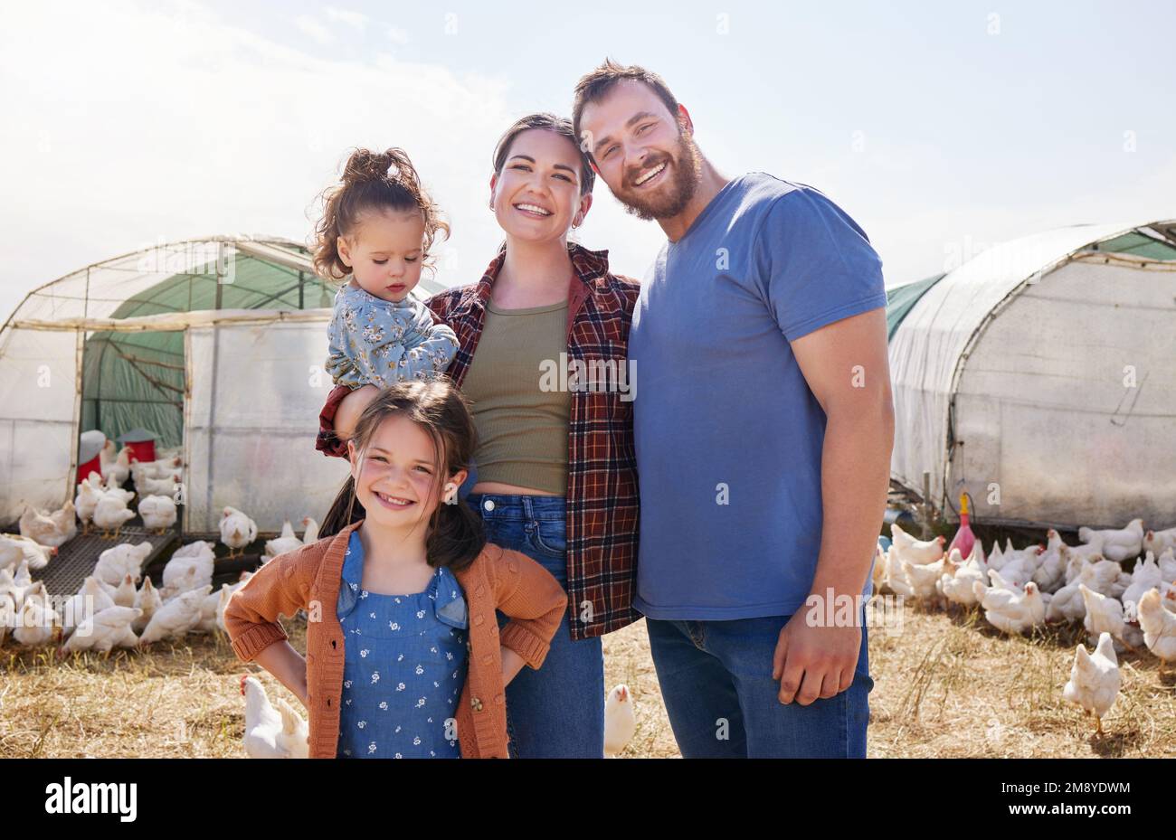 Raising children on a farm is fun. a couple and their two daughters on ...