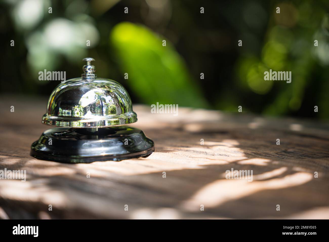 Customer hand ringing service bell at coffee cafe shop for calling the ...