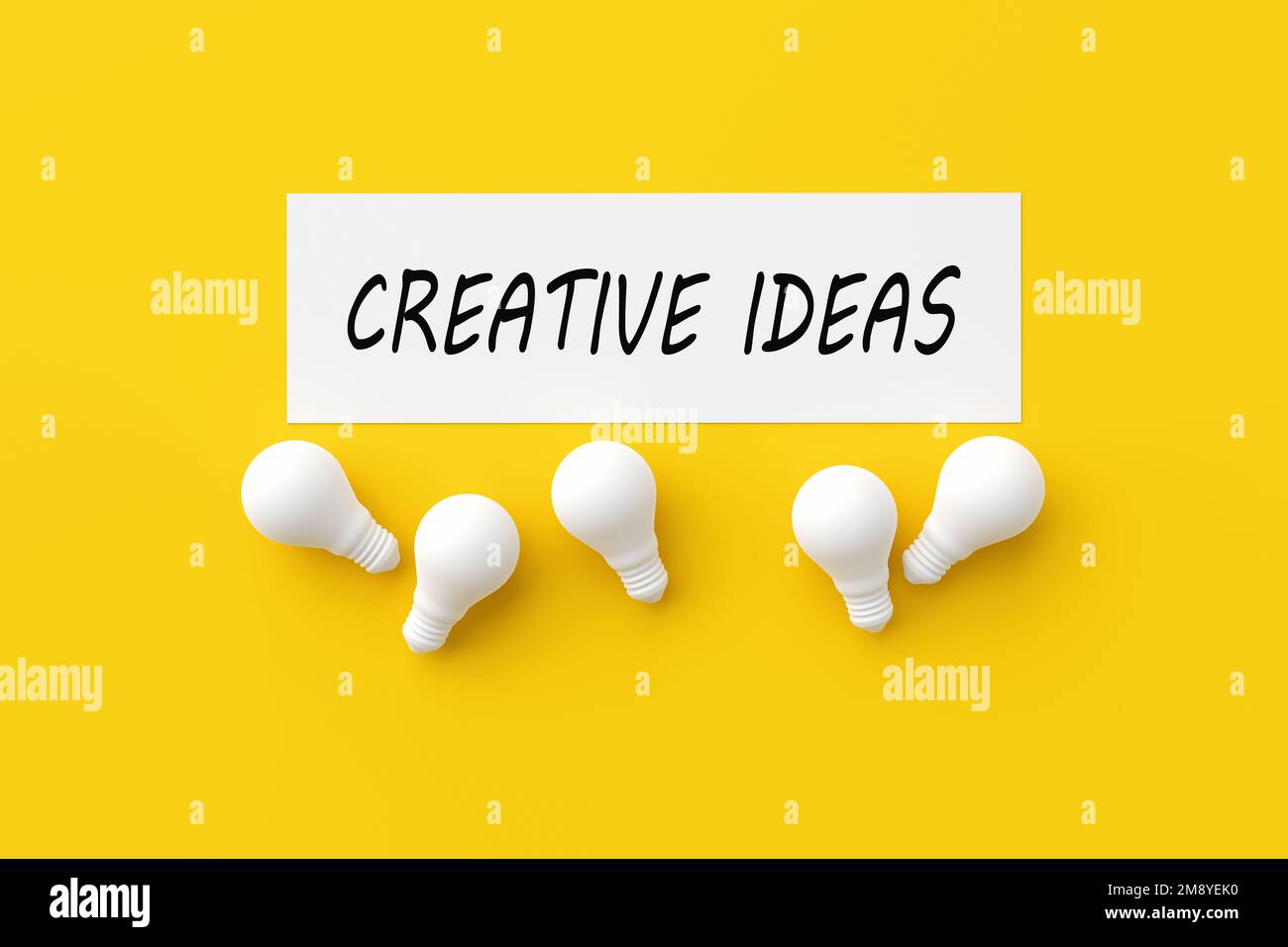 The word creative ideas on white paper with light bulbs. Creative ...