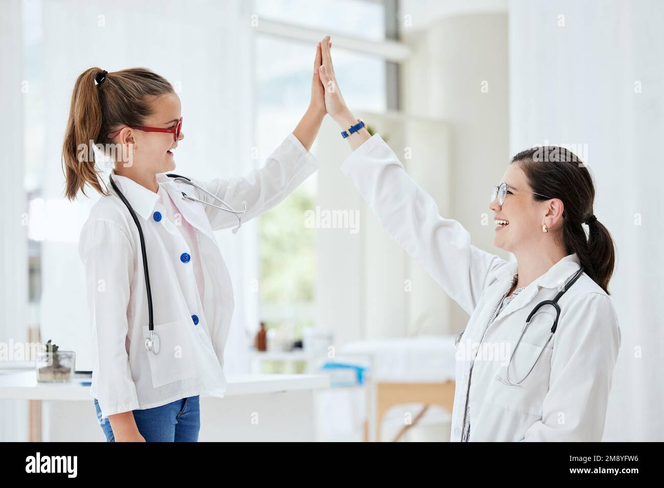 One day youll be here too. a little girl giving a doctor a high five at ...