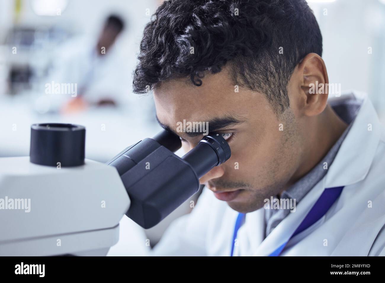 The slides always reveal their secrets. a young male lab technician ...