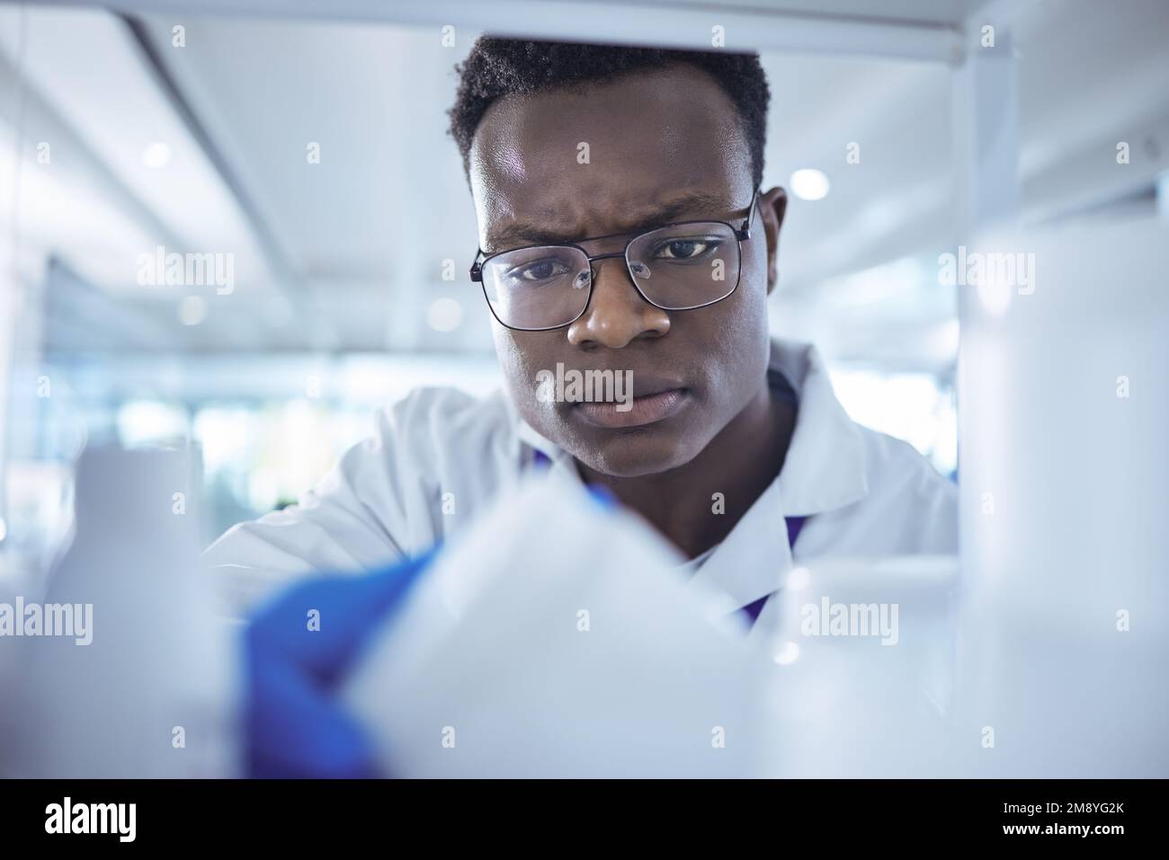 The magic ingredient. a young male scientist looking for a product in ...