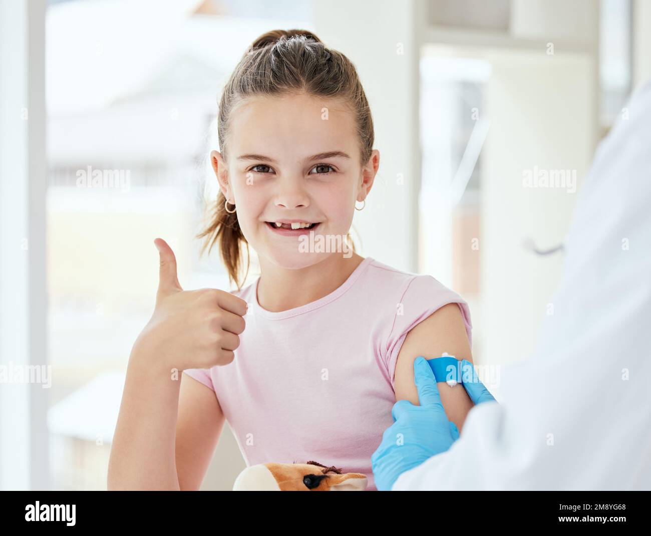 That didnt hurt at all. an unrecognizable doctor applying a plaster to ...