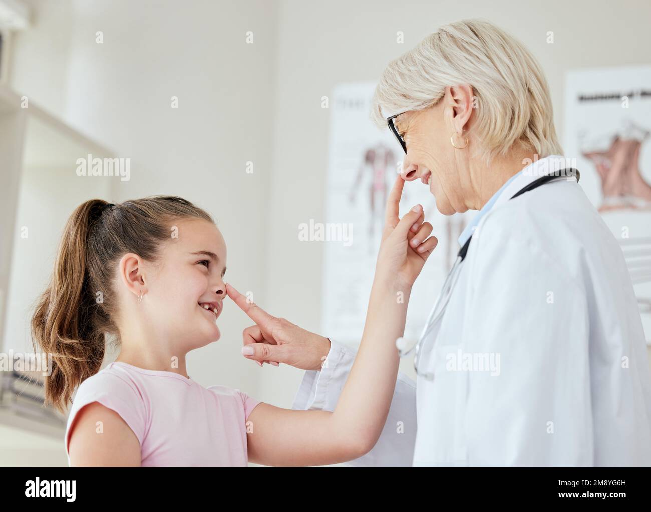 She nose whats best. a little girl at a checkup at a hospital Stock ...