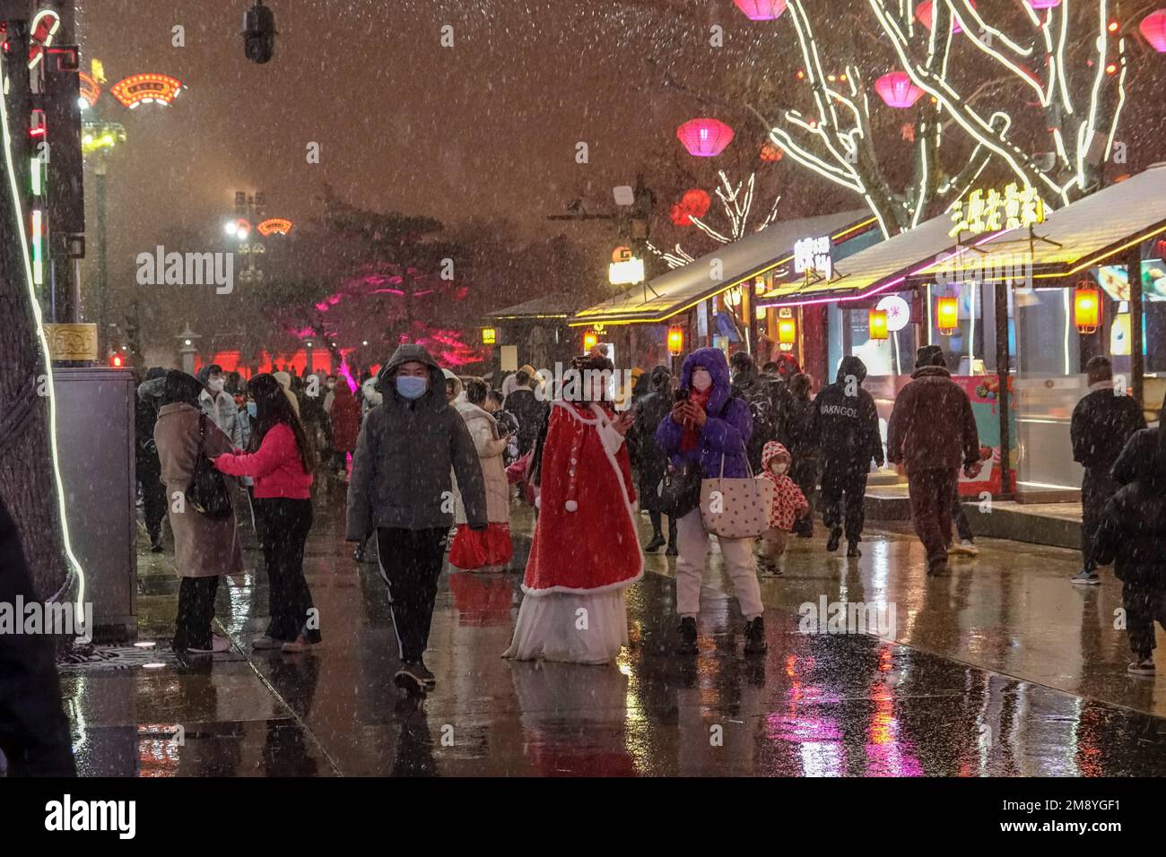 Tourists visit the Grand Tang Mall in the snow in Xi'an City, northwest ...