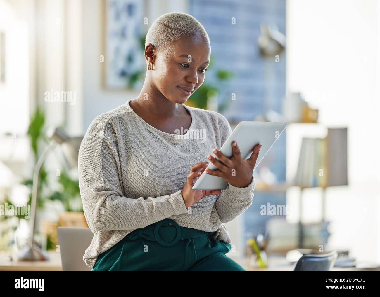 She doesnt stop working. a young businesswoman using a digital tablet ...