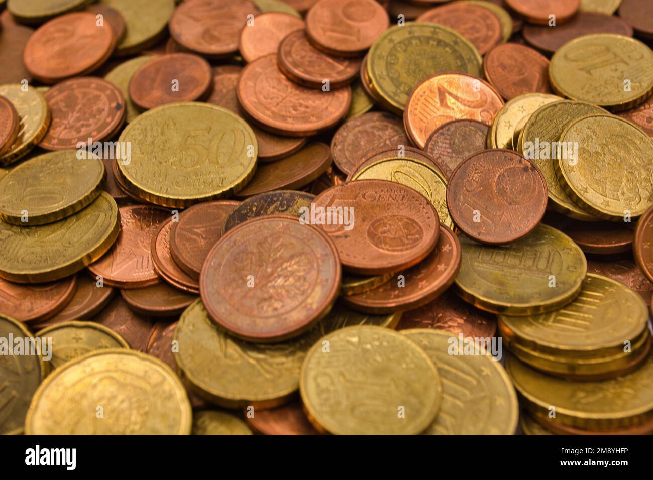 A closeup of yellow and red coins Stock Photo - Alamy