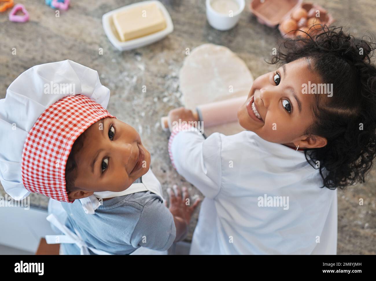 Come watch us bake. a little boy and his sister baking together at home ...
