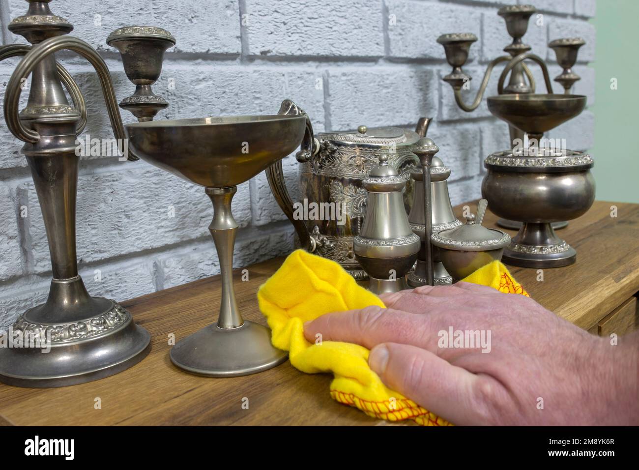 Man dusting wooden cabinet hi-res stock photography and images - Alamy