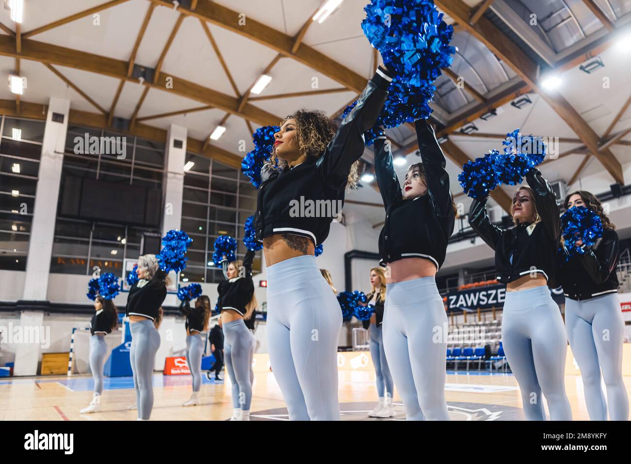 Low-angle shot of cheerleaders during a dance with their hands in the ...