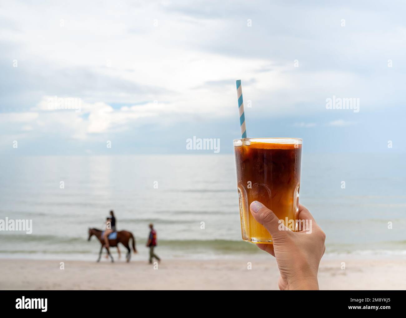 A glass of fresh iced orange americano decorated with sliced orange ...