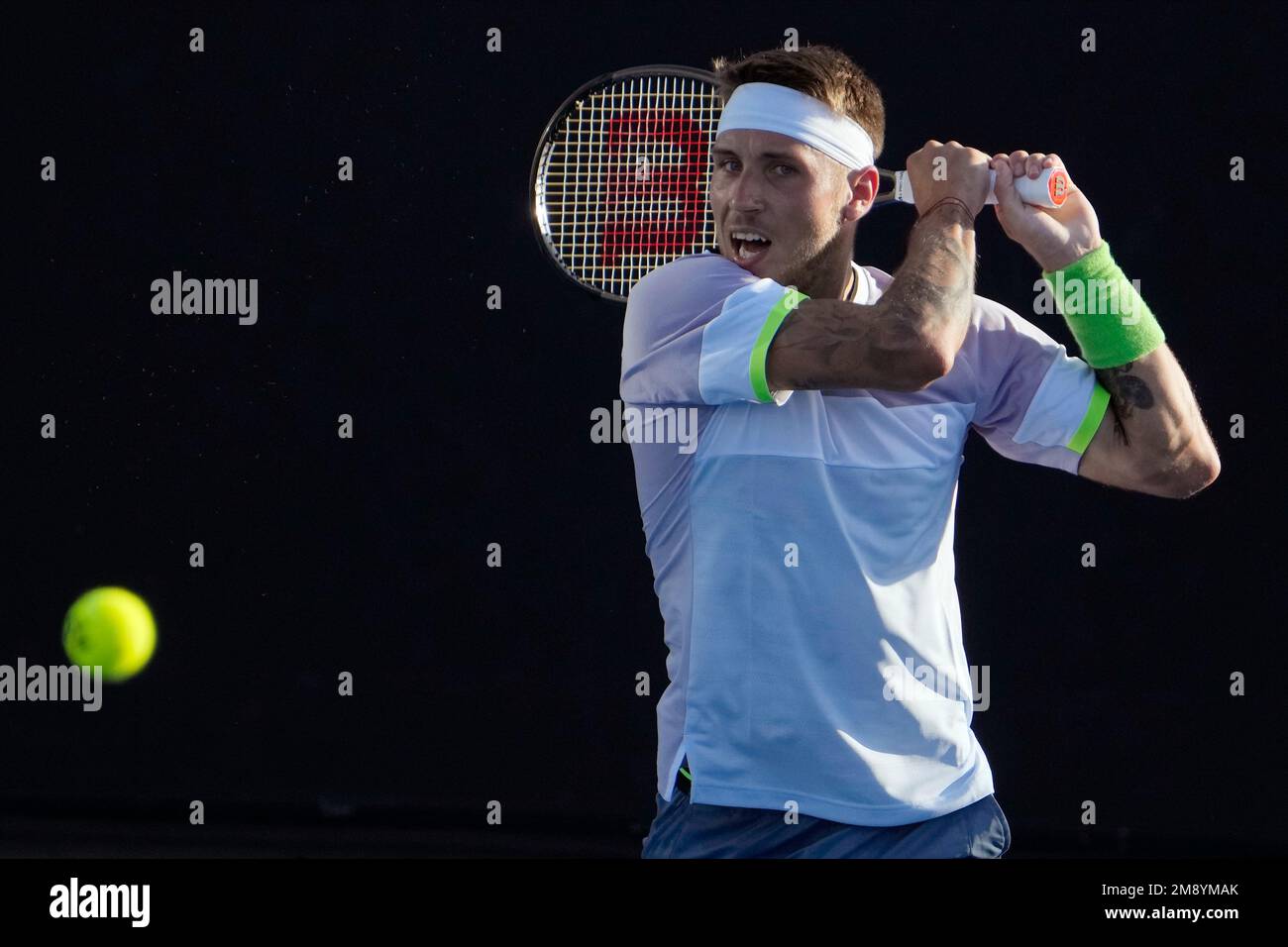 Alex Molcan of Slovakia plays a backhand return to Stan Wawrinka of ...