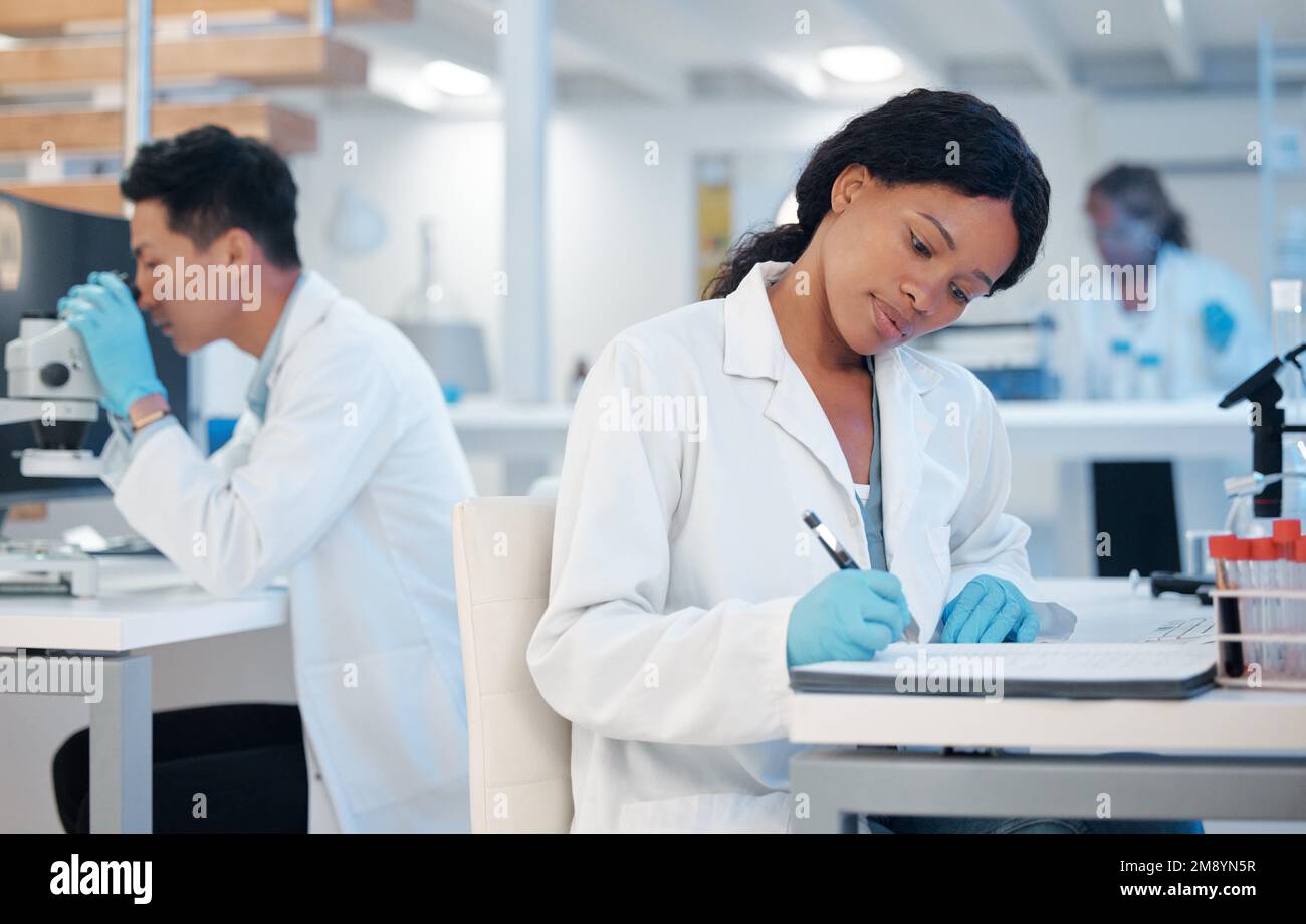 her genius cannot be tamed. a young woman making notes while working in ...
