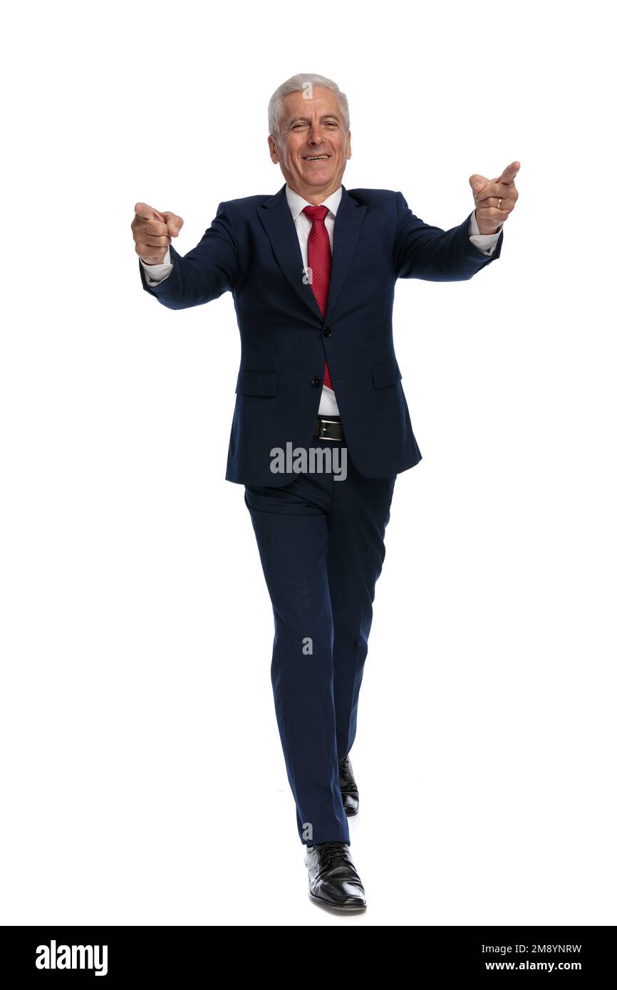 full body picture of an old businessman walking and pointing towards ...