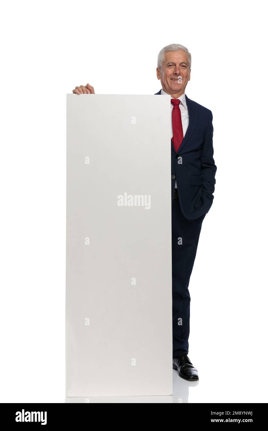 Full body picture of and relaxed businessman presenting something on a ...
