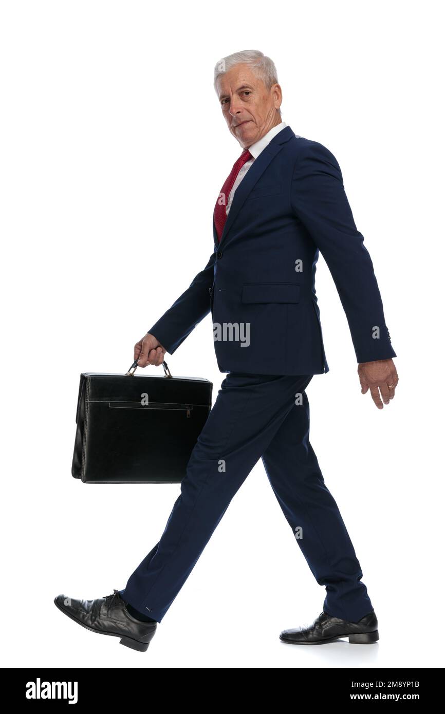 Full body picture of an old businessman walking to the side with a ...