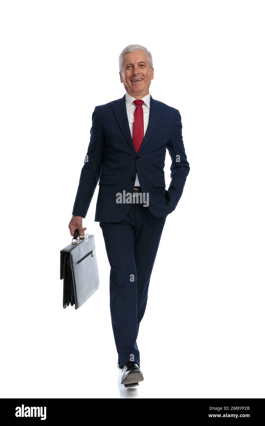 Full body picture of an happy businessman walking to the camera with a ...
