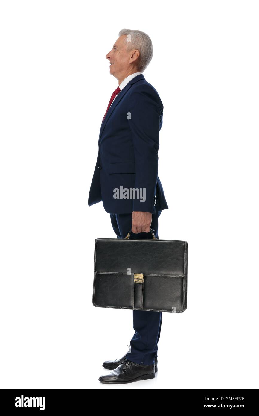 Full body picture of an old businessman standing and waiting in line ...
