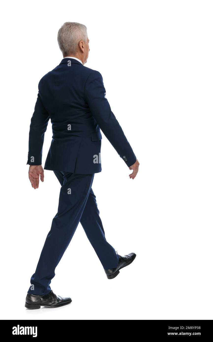 full body picture and rear view of an old businessman walking on his ...