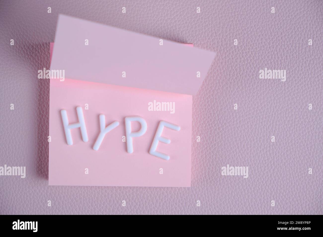 Word hype laid out white letters pink piece paper.Concept hype ...