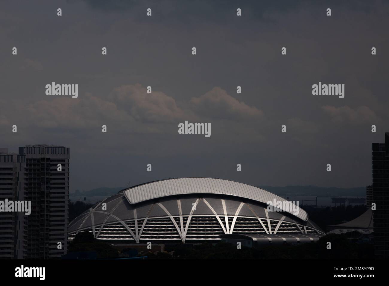Dark cloudy sky, copyspace. Skyline view of The Kallang, stadium ...