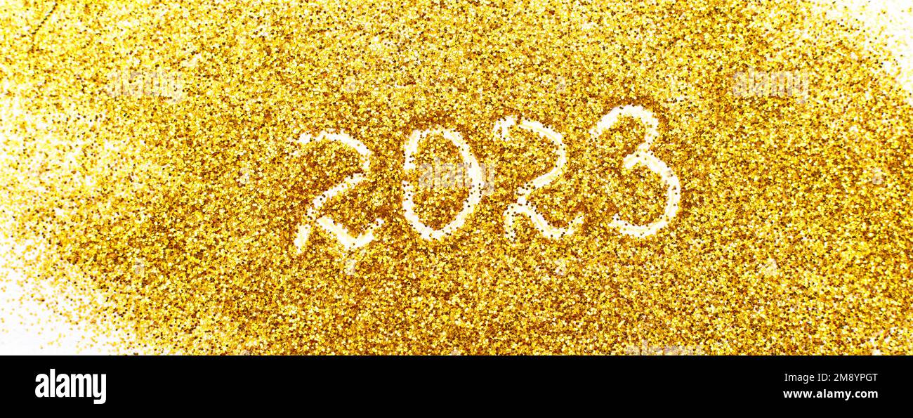 the number 2023 written on golden confetti. christmas or new year ...